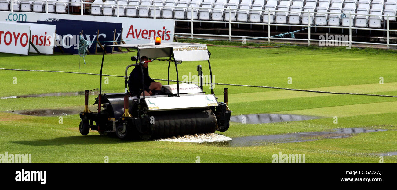 As the sun comes out ground staff soak up water from the out field. The ...