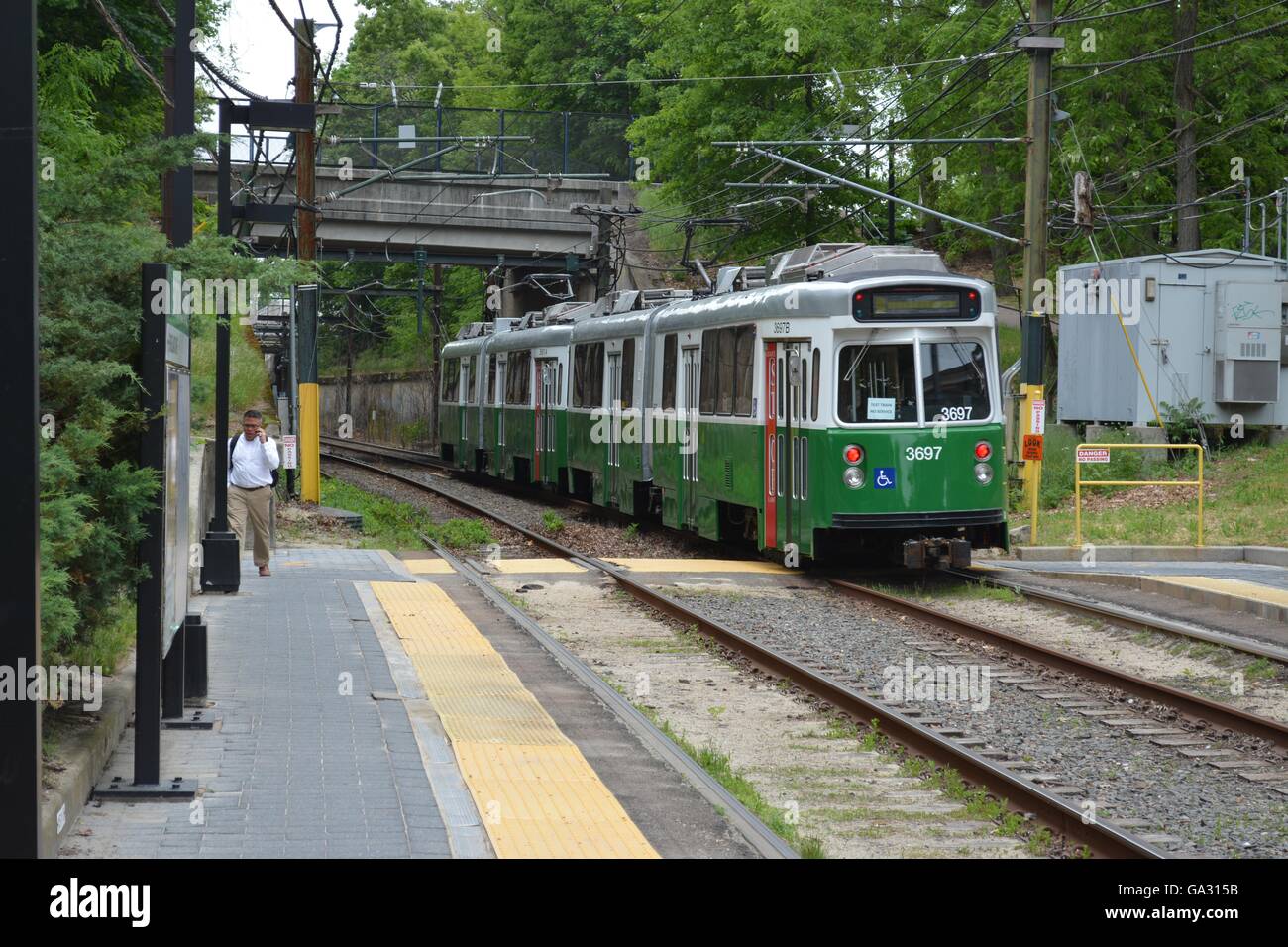 An MBTA light rail vehicle (LRV) or trolley passing through the Newton ...