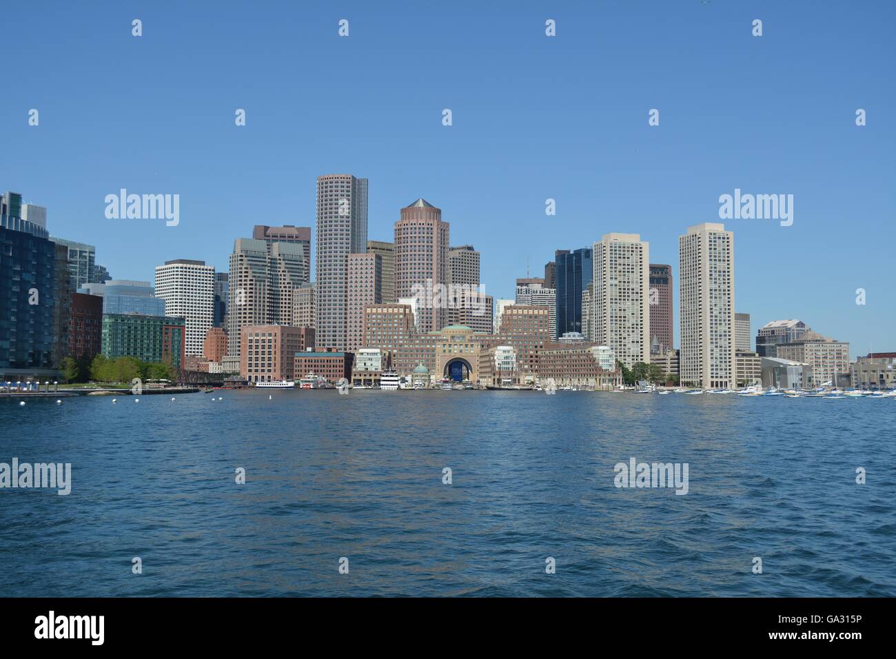 The Boston Skyline seen from the Boston harbor with sail boats and ...