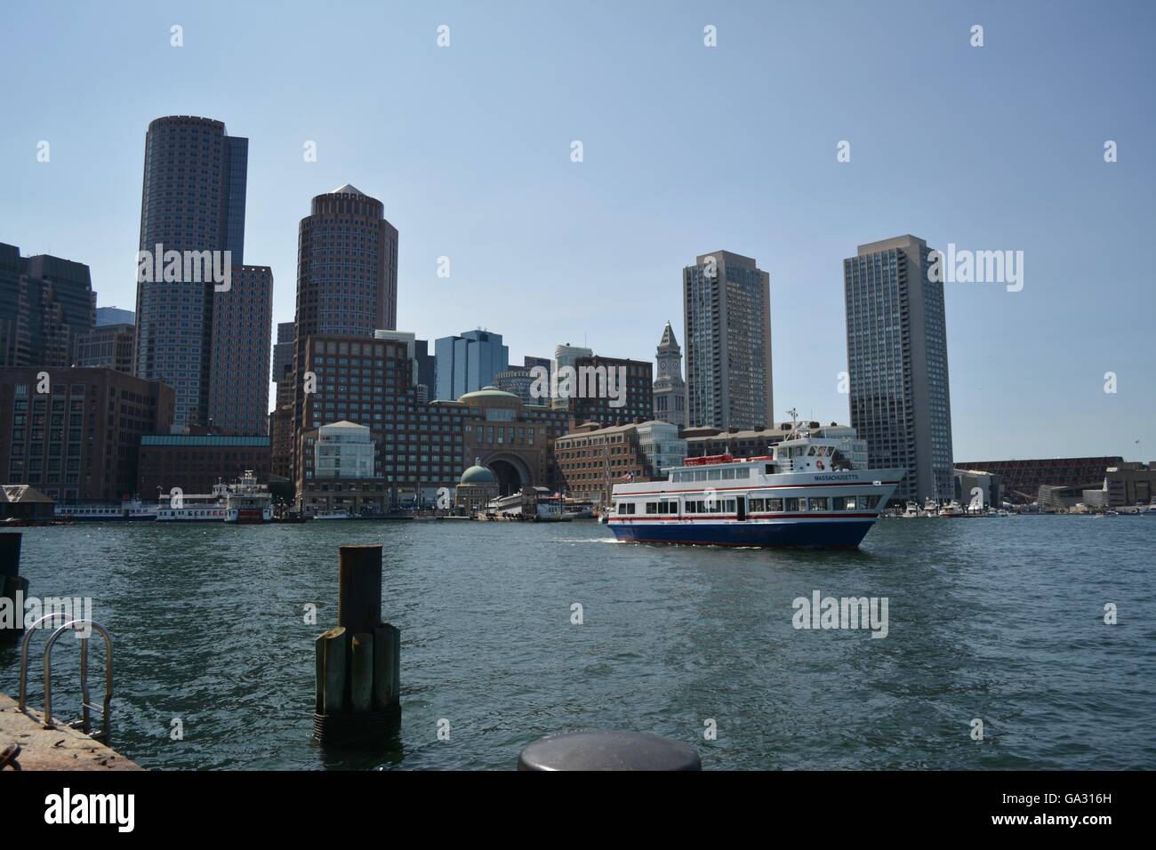 The Boston Skyline seen from the Boston harbor with sail boats and ...
