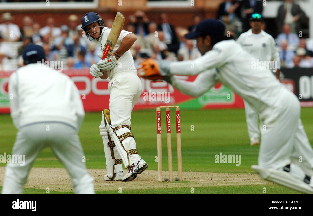 Indian wicketkeeper Mahendra Dhoni (right) trys to make a catch from ...