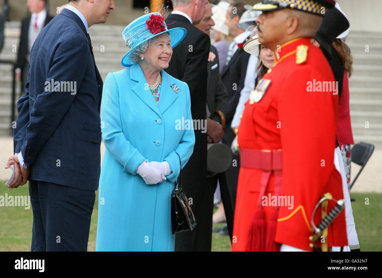 Queen Elizabeth II smiles as she meets guests including the Captain of ...