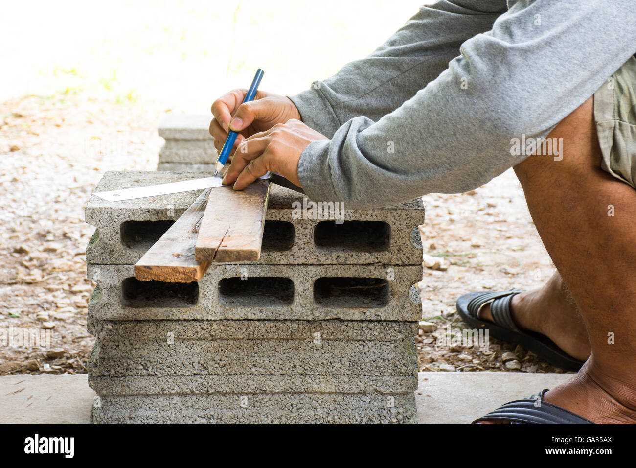 Male carpenter working with wood pencil at work place.Background ...