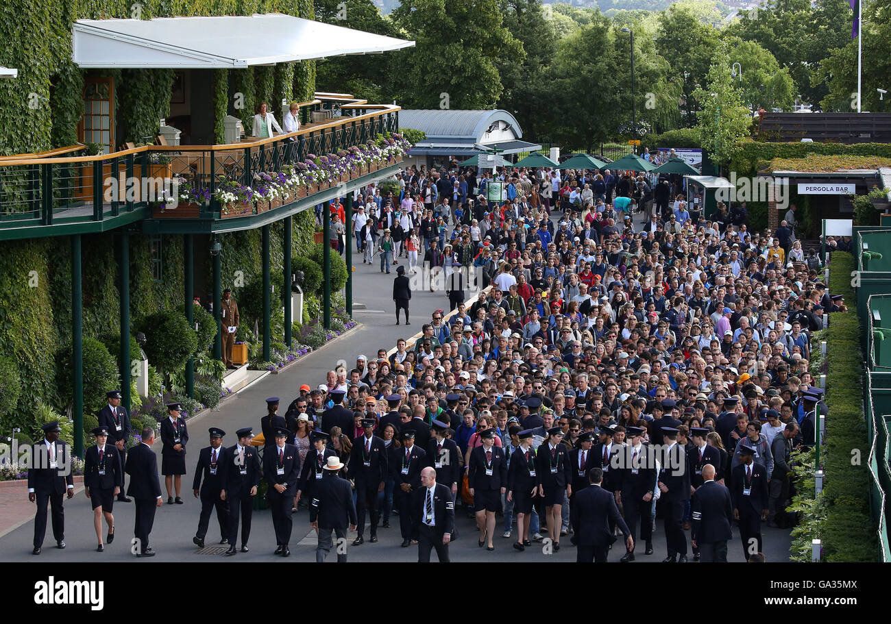 Spectators are led in on day six of the Wimbledon Championships at the ...