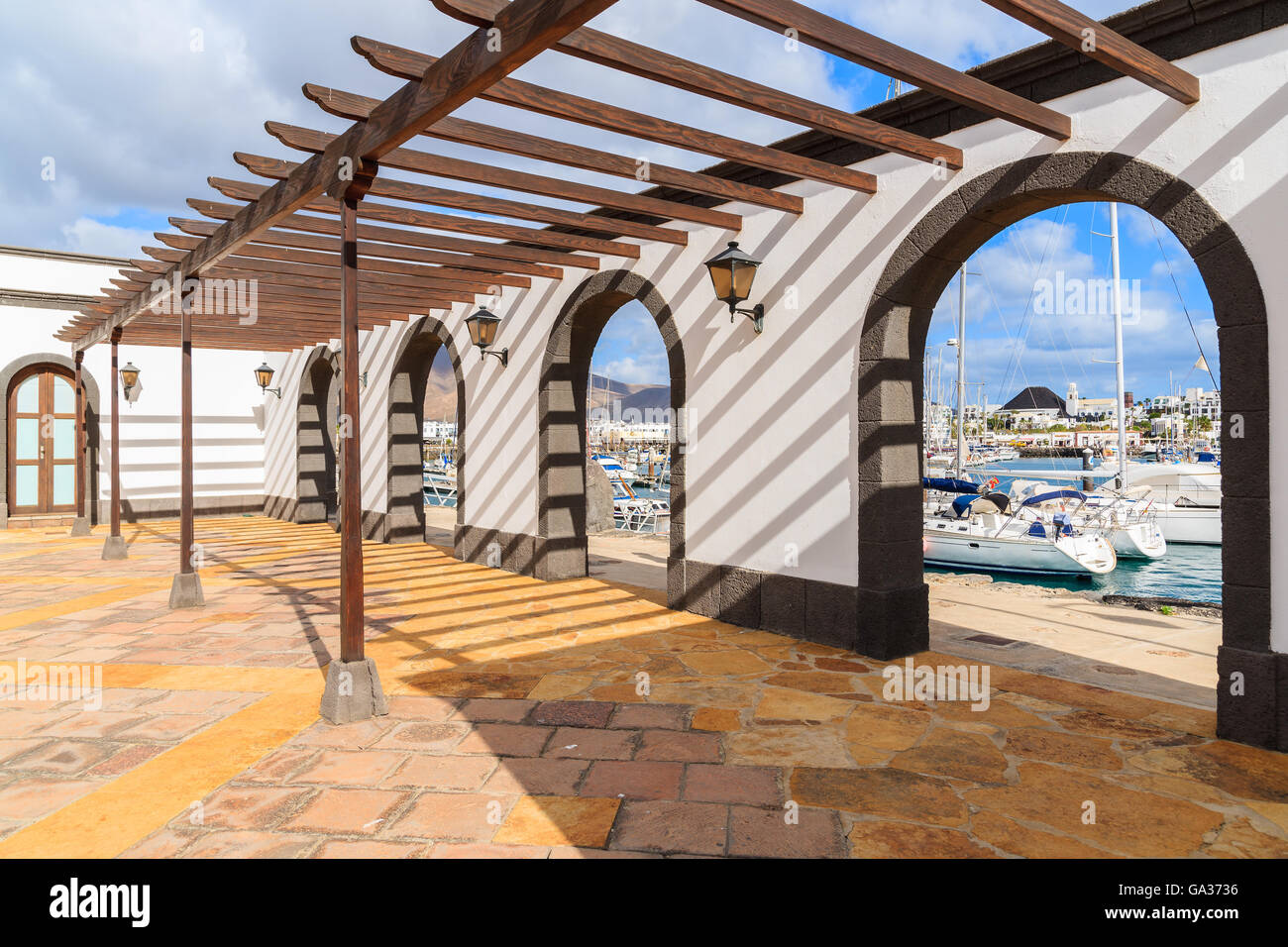 Canary style building with view of marina Rubicon thorough arches ...