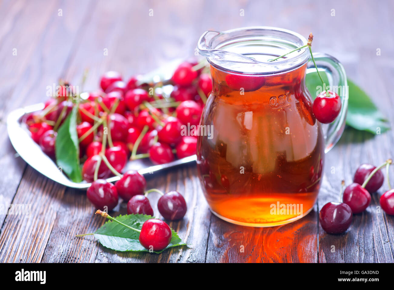 cherry juice in jug and on a table Stock Photo - Alamy