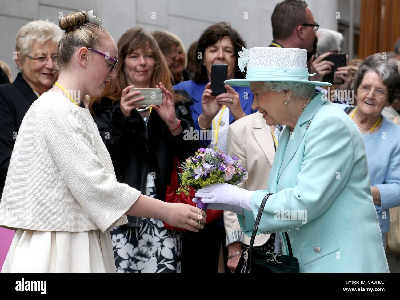 Islelagh Shaw (11), presents Queen Elizabeth II with flowers as she ...