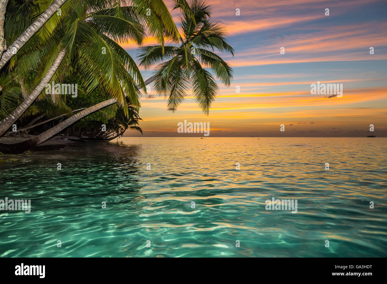 sunset on a paradise island from the water Stock Photo - Alamy