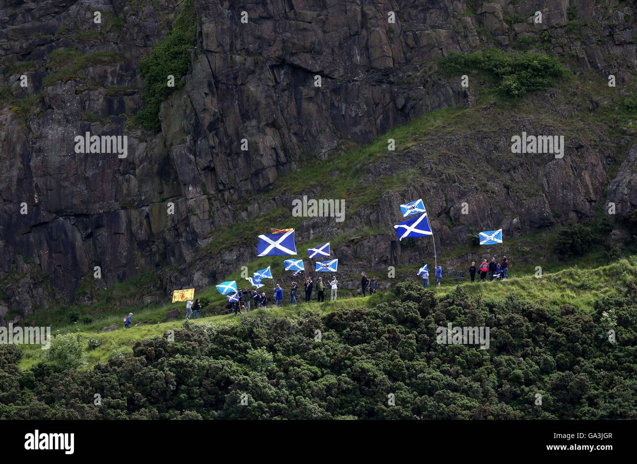 Scottish independence supporters wave Saltire flags on Edinburgh's ...