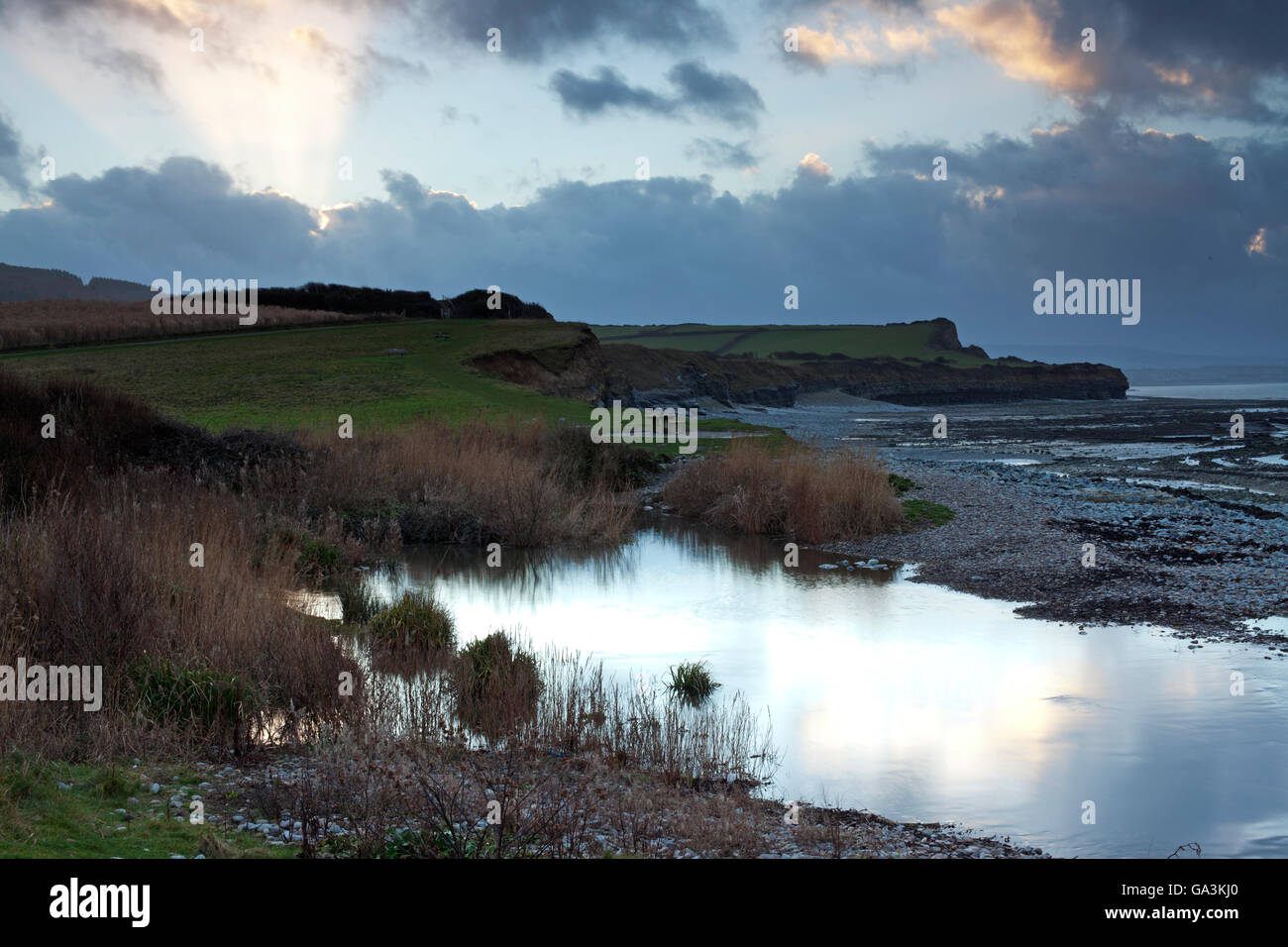 Sunrays through the clouds over the cliffs of Kilve Beach close to ...