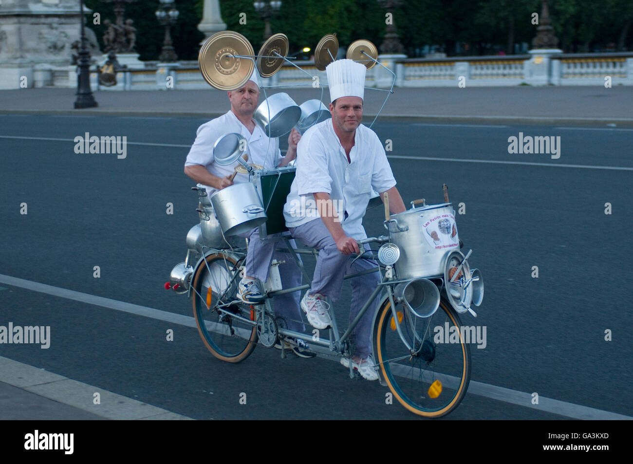 Two cooks, chefs, playing percussions on a bike during Fete de la ...