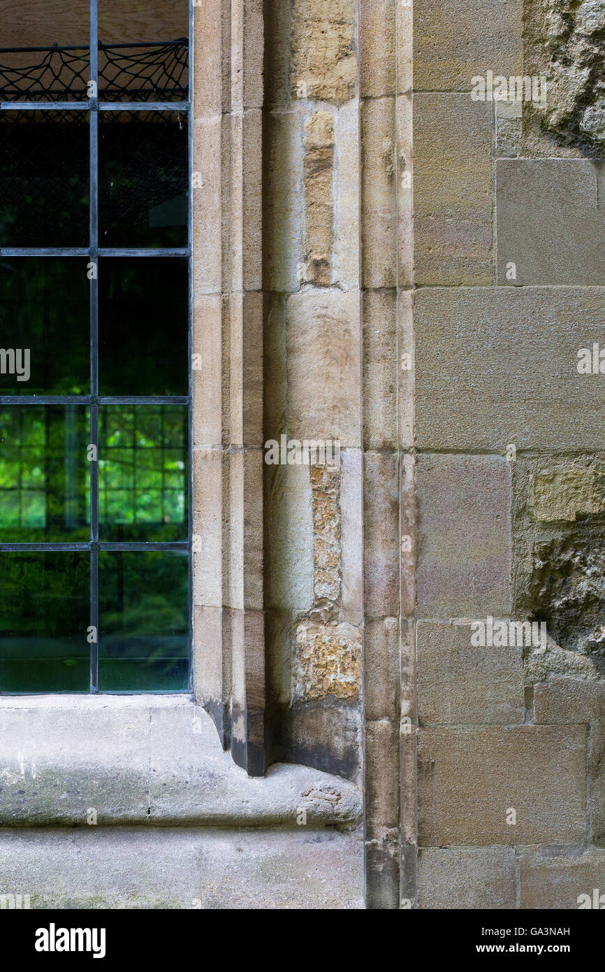 Leaded glass window in limestone wall green garden background Stock ...