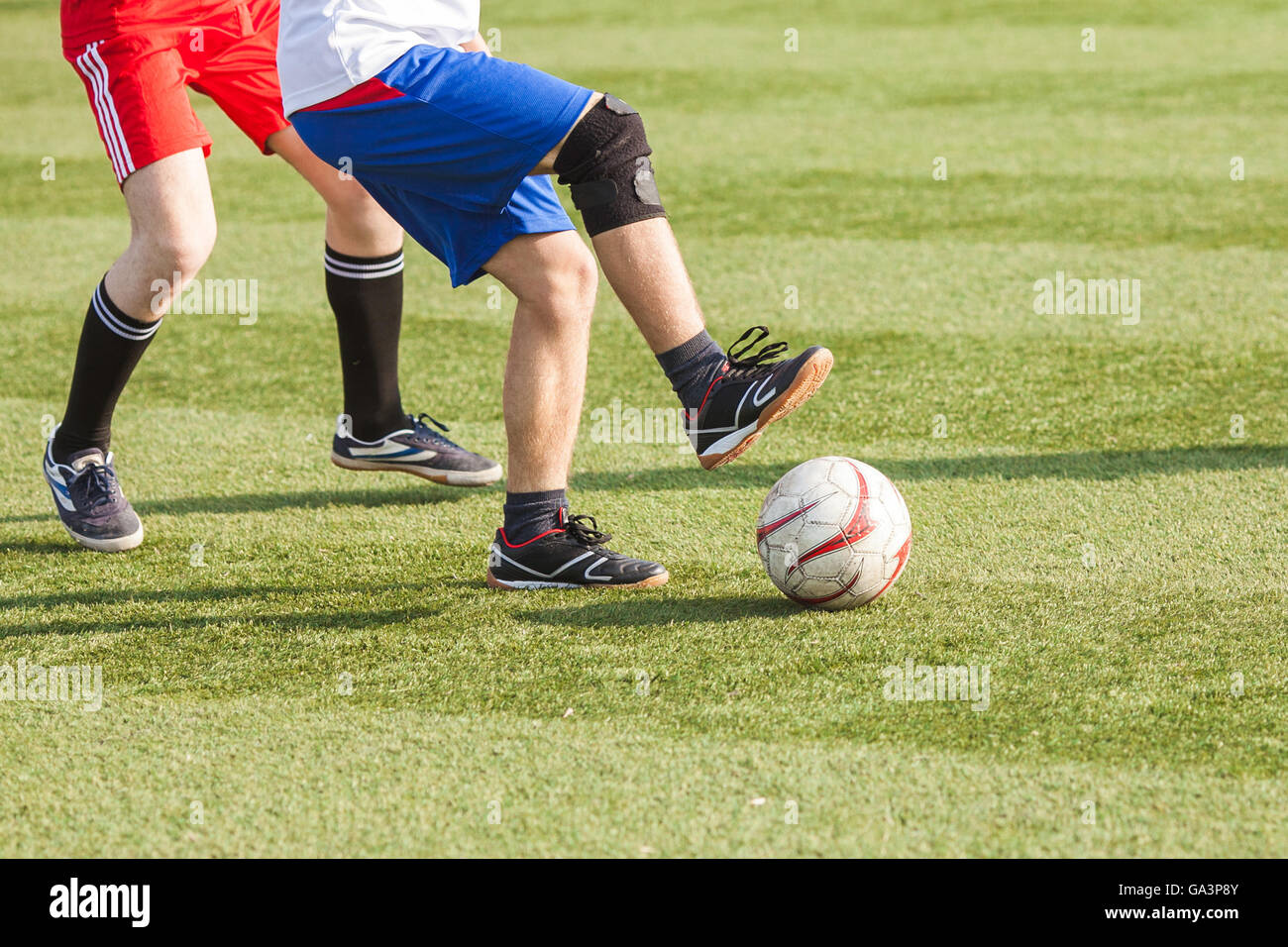 Feet of players in soccer with a ball close-up Stock Photo - Alamy
