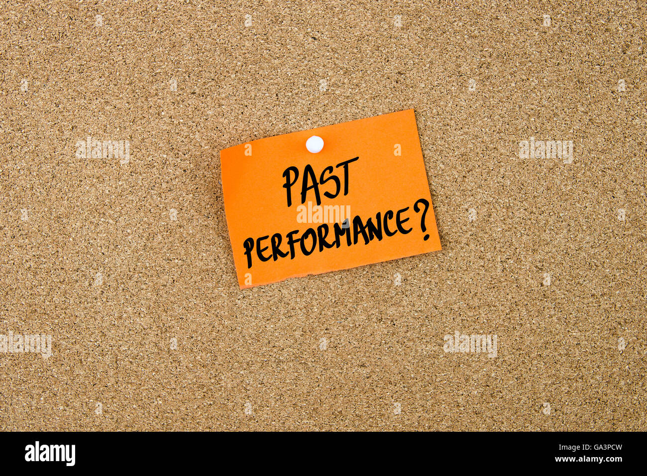 Past Performance written on orange paper note note pinned on cork board ...