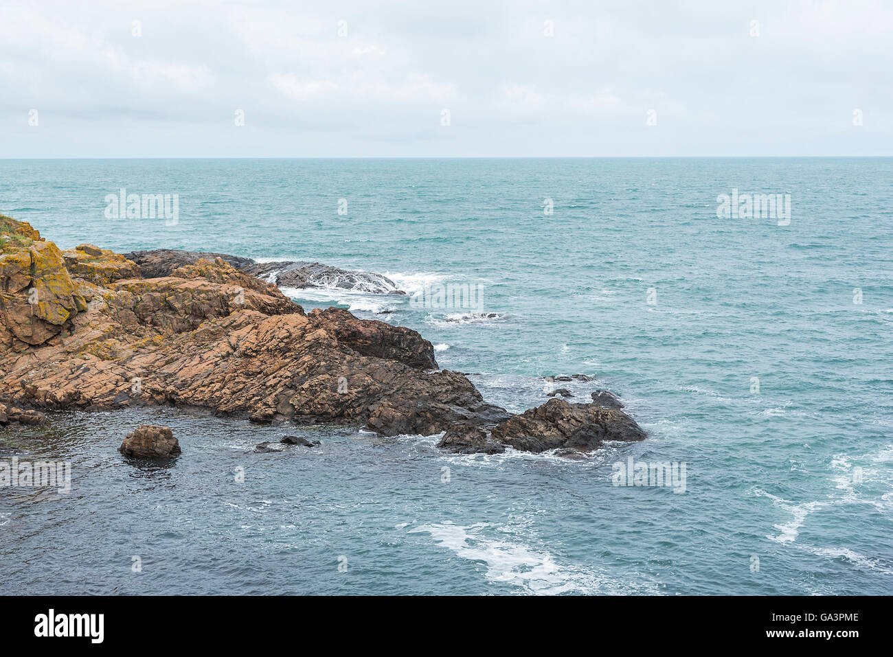 A rocky coast and dramatic sea waves Stock Photo - Alamy