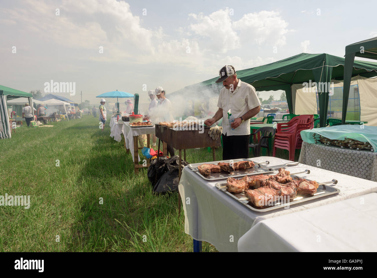 People cooking shashlik BBQ kebabs an an open fire outdoors Stock Photo ...