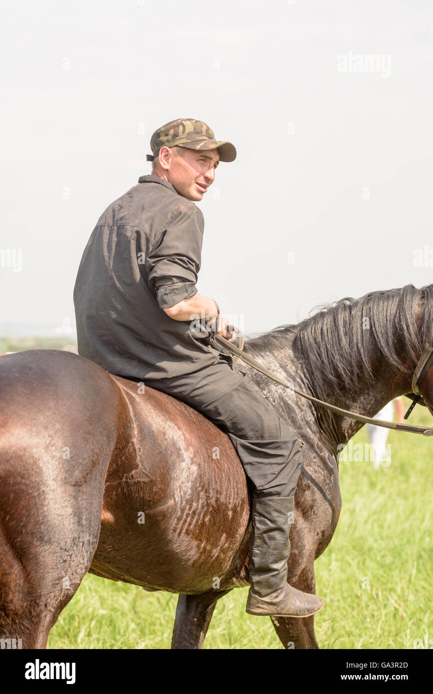 Man riding a brown horse outside without a saddle or safety hat Stock ...