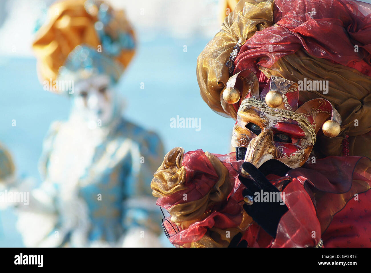 Masketeers in lavish decorative red costume at the Venice Mask Festival ...