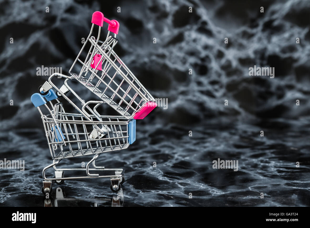 Miniature shopping charts on black marble background Stock Photo - Alamy
