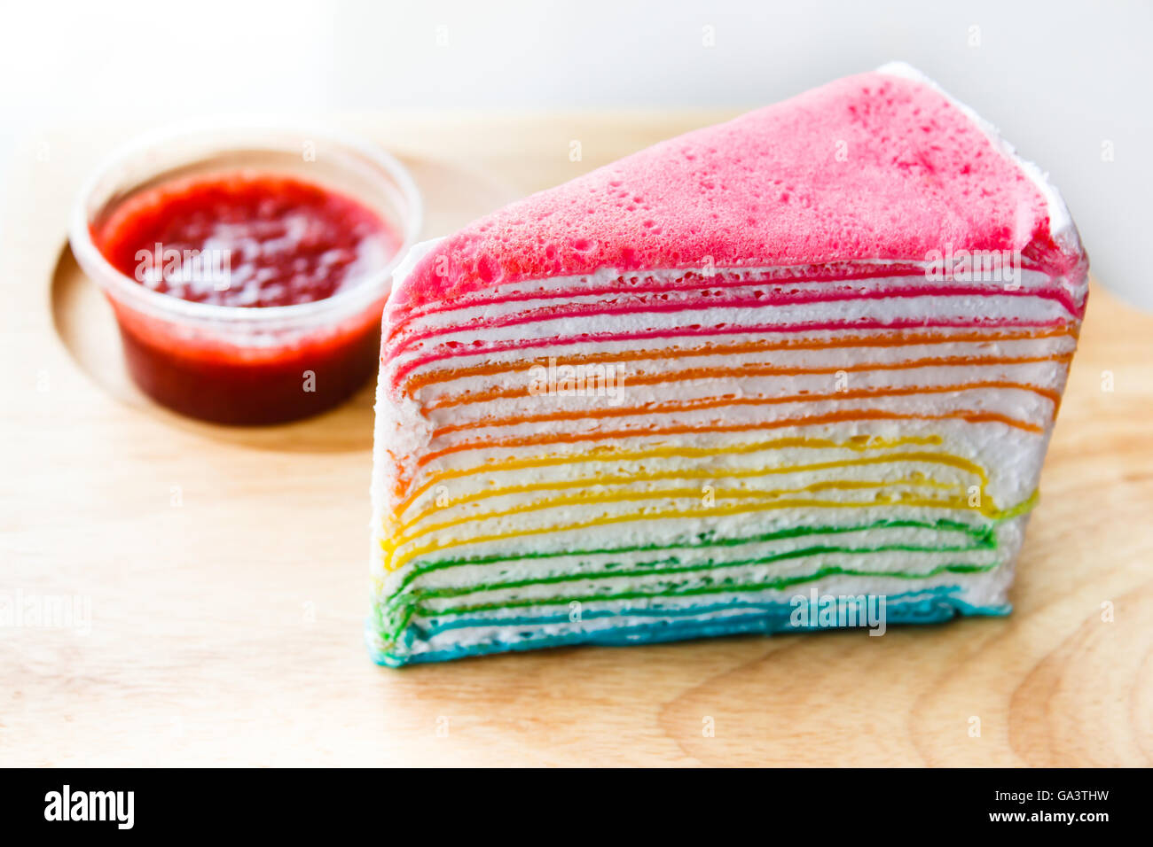 Rainbow crape cake with strawberry sauce Stock Photo - Alamy