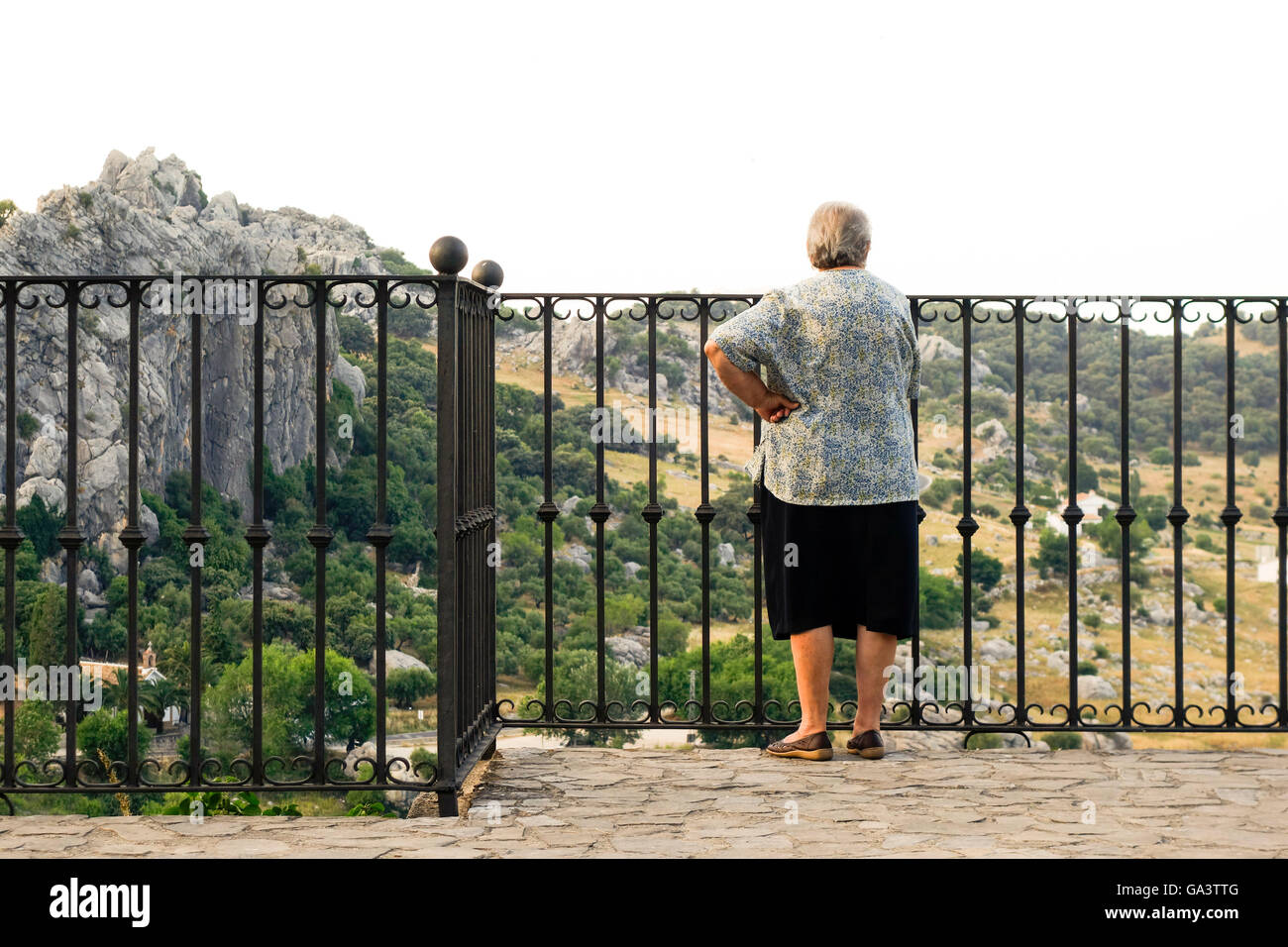 Senior spanish woman watching from view point, spanish village ...