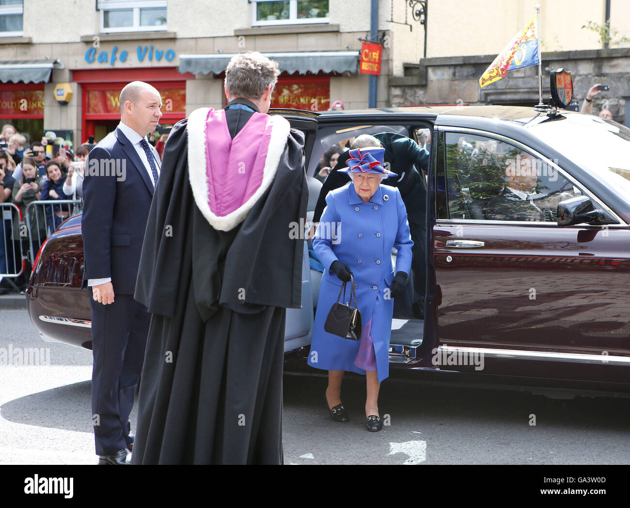 Queen Elizabeth II is greeted by Reverend Neil Gardner (back to camera ...