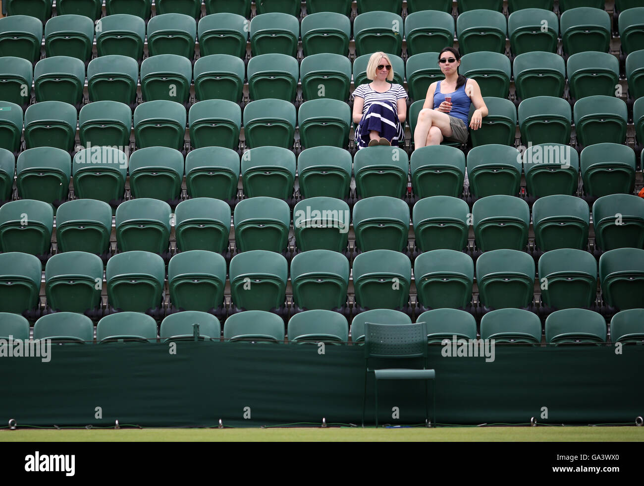 Spectators in the stands on court three on day Seven of the Wimbledon ...