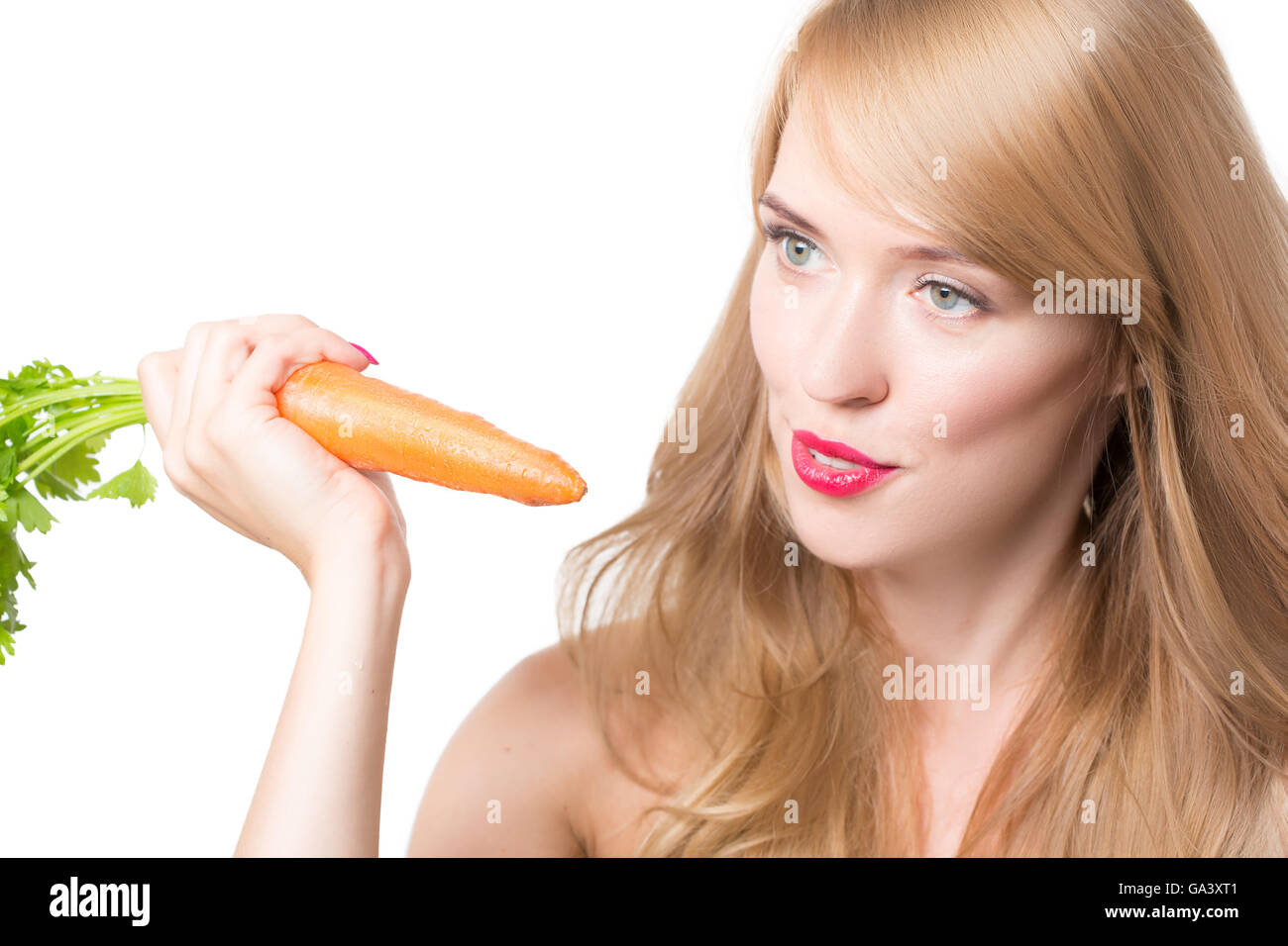 Young happy woman eating carrots Stock Photo - Alamy