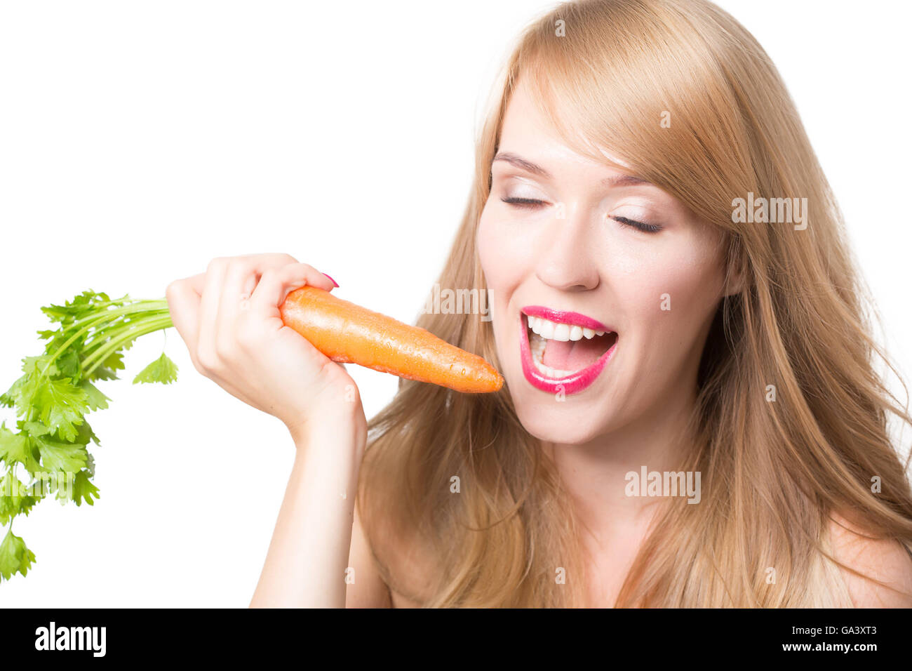 Young happy woman eating carrots Stock Photo - Alamy