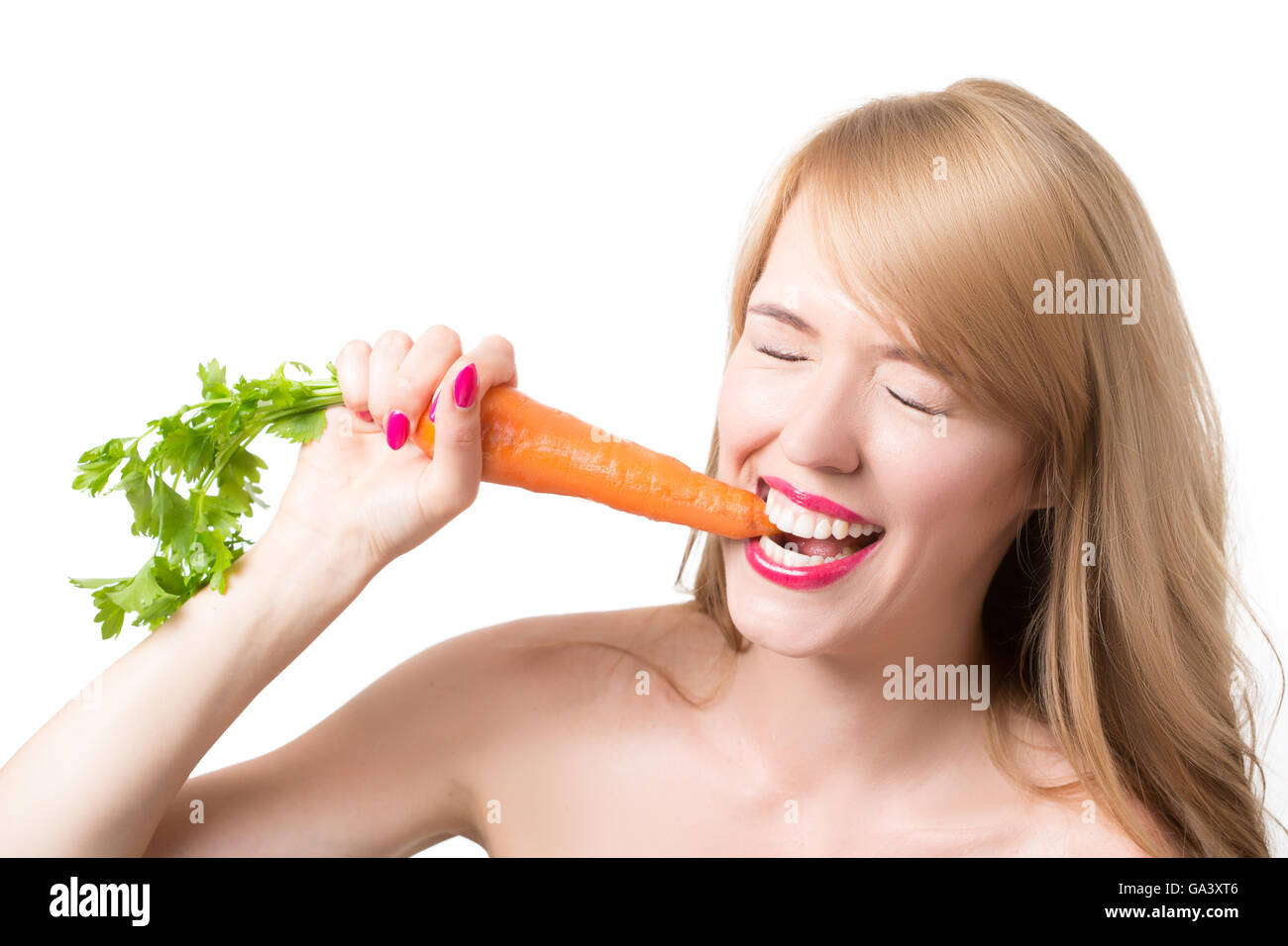 Young happy woman eating carrots Stock Photo - Alamy