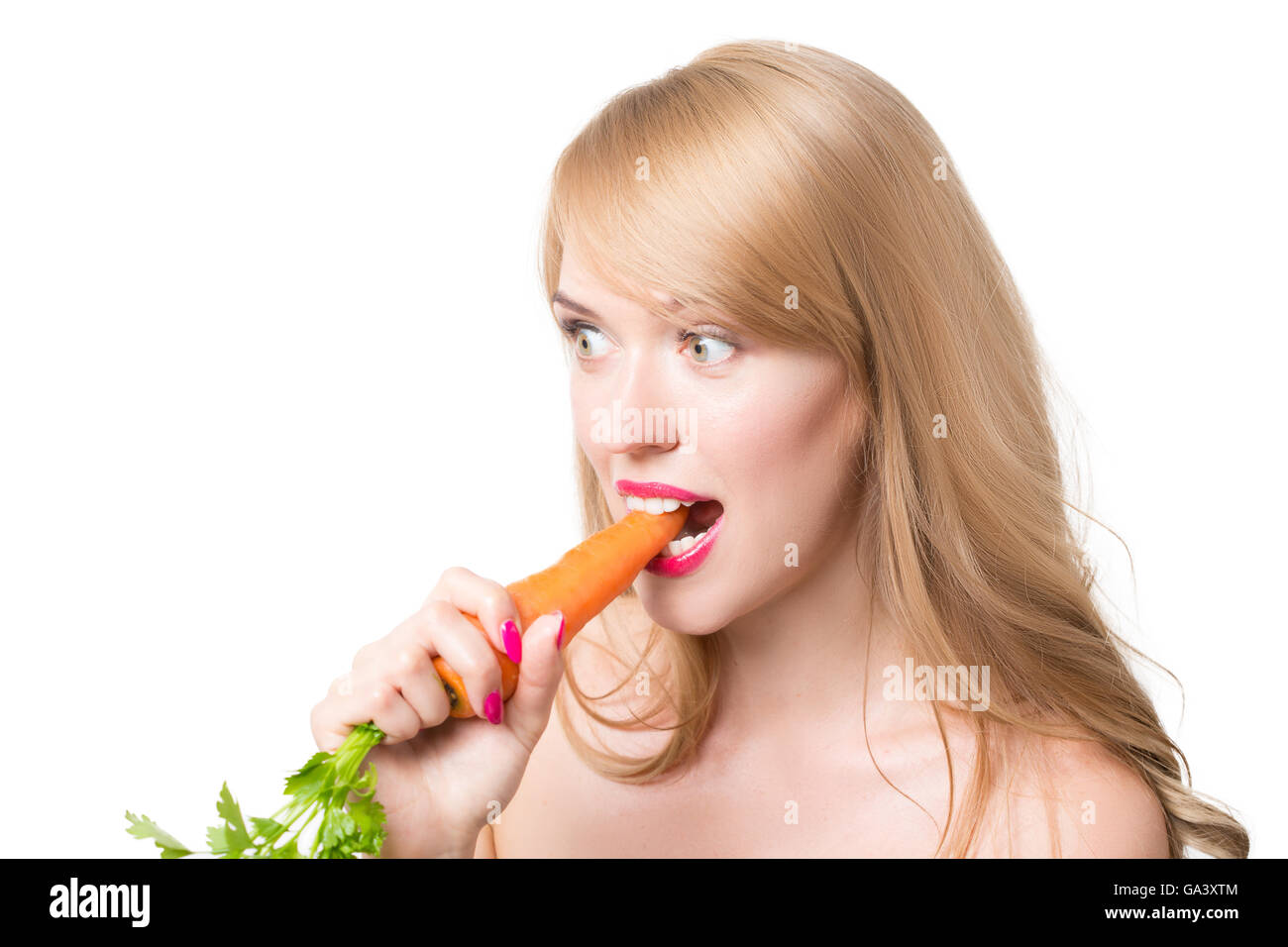 Young happy woman eating carrots Stock Photo - Alamy