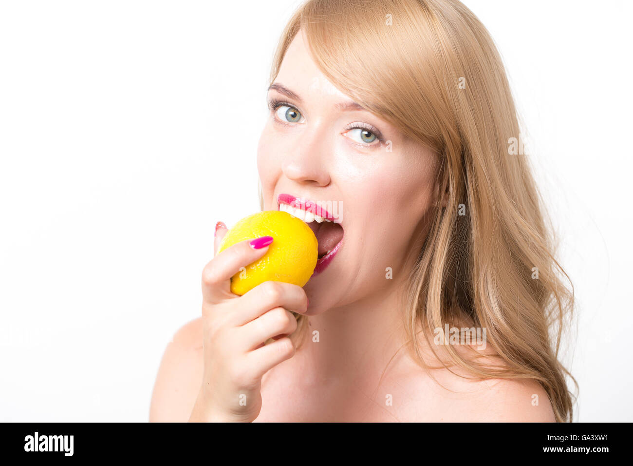 girl biting a lemon Stock Photo - Alamy