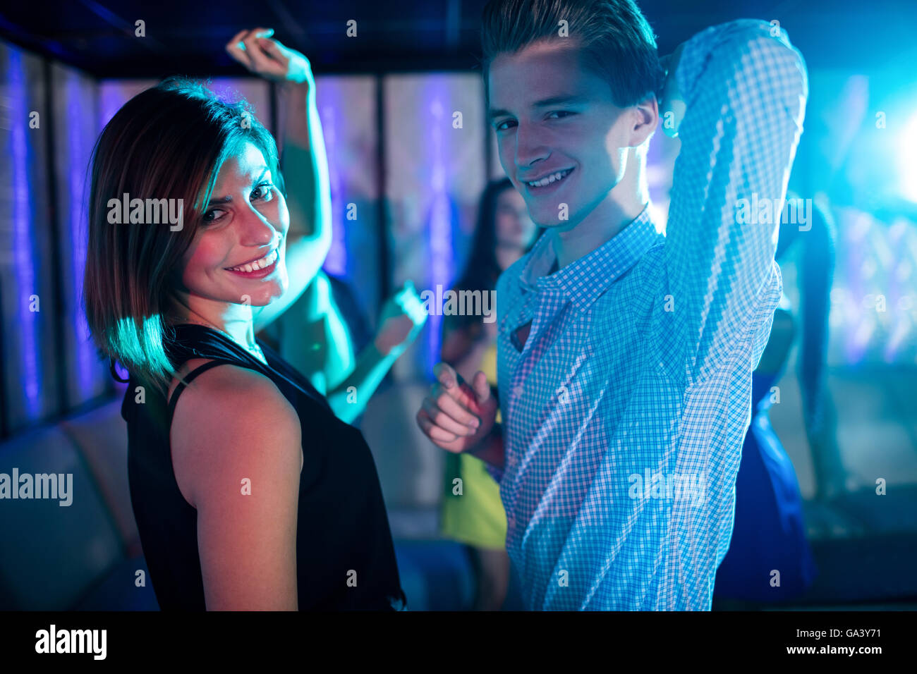 Smiling friends dancing on dance floor Stock Photo - Alamy