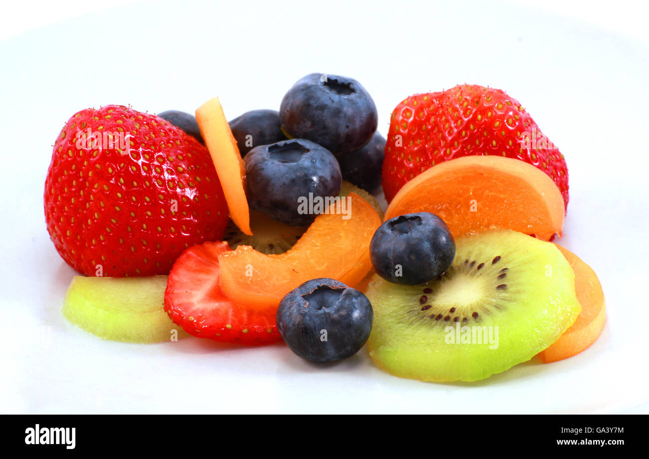 different fruits - strawberry, blueberry and apricot, kiwi - placed ...