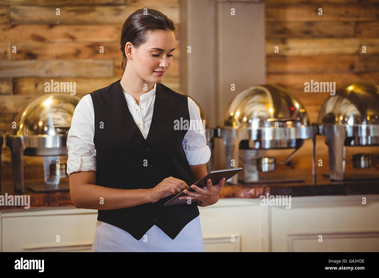 Waitress using a tablet Stock Photo - Alamy