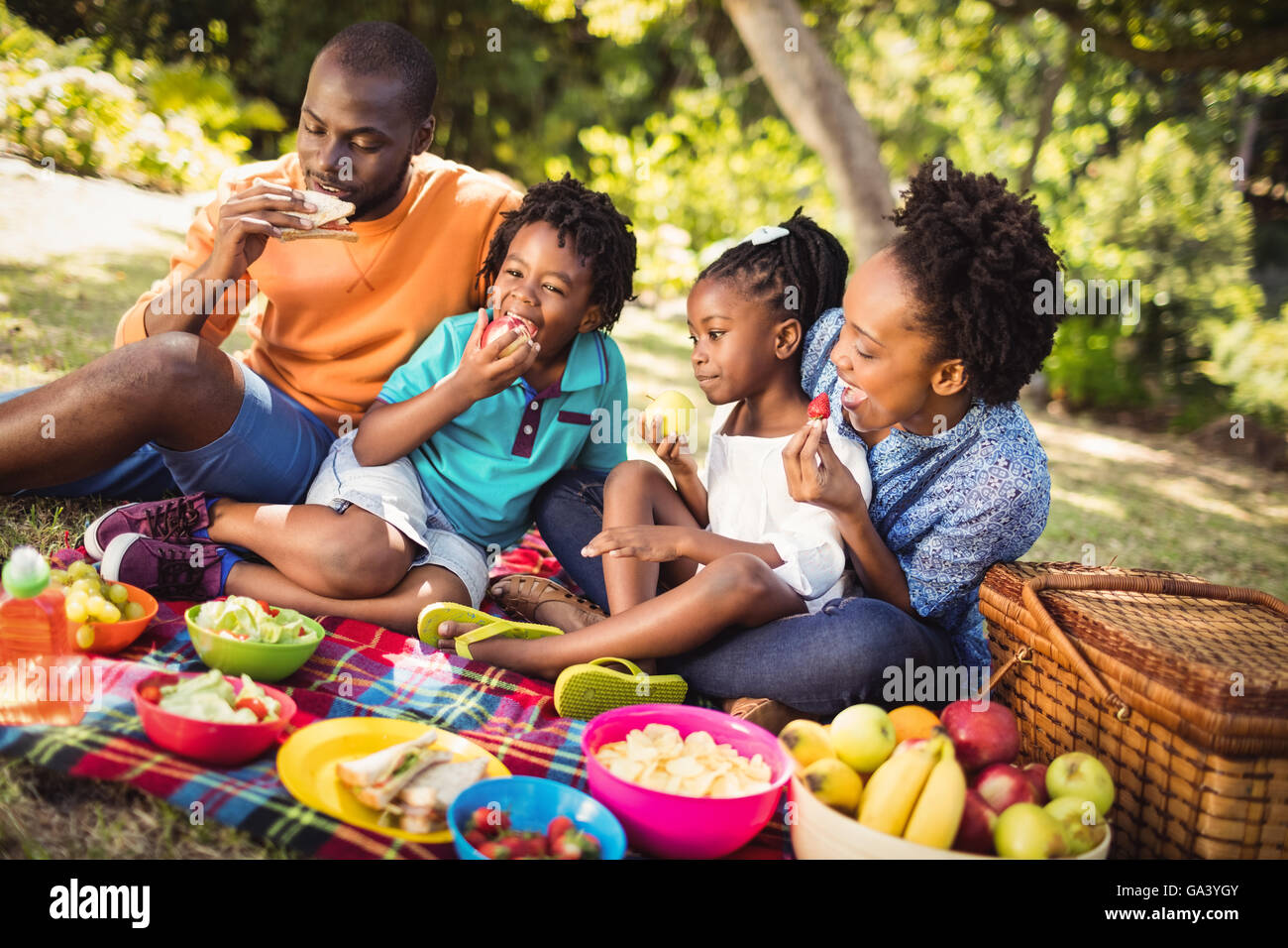 Happy family eating together Stock Photo - Alamy