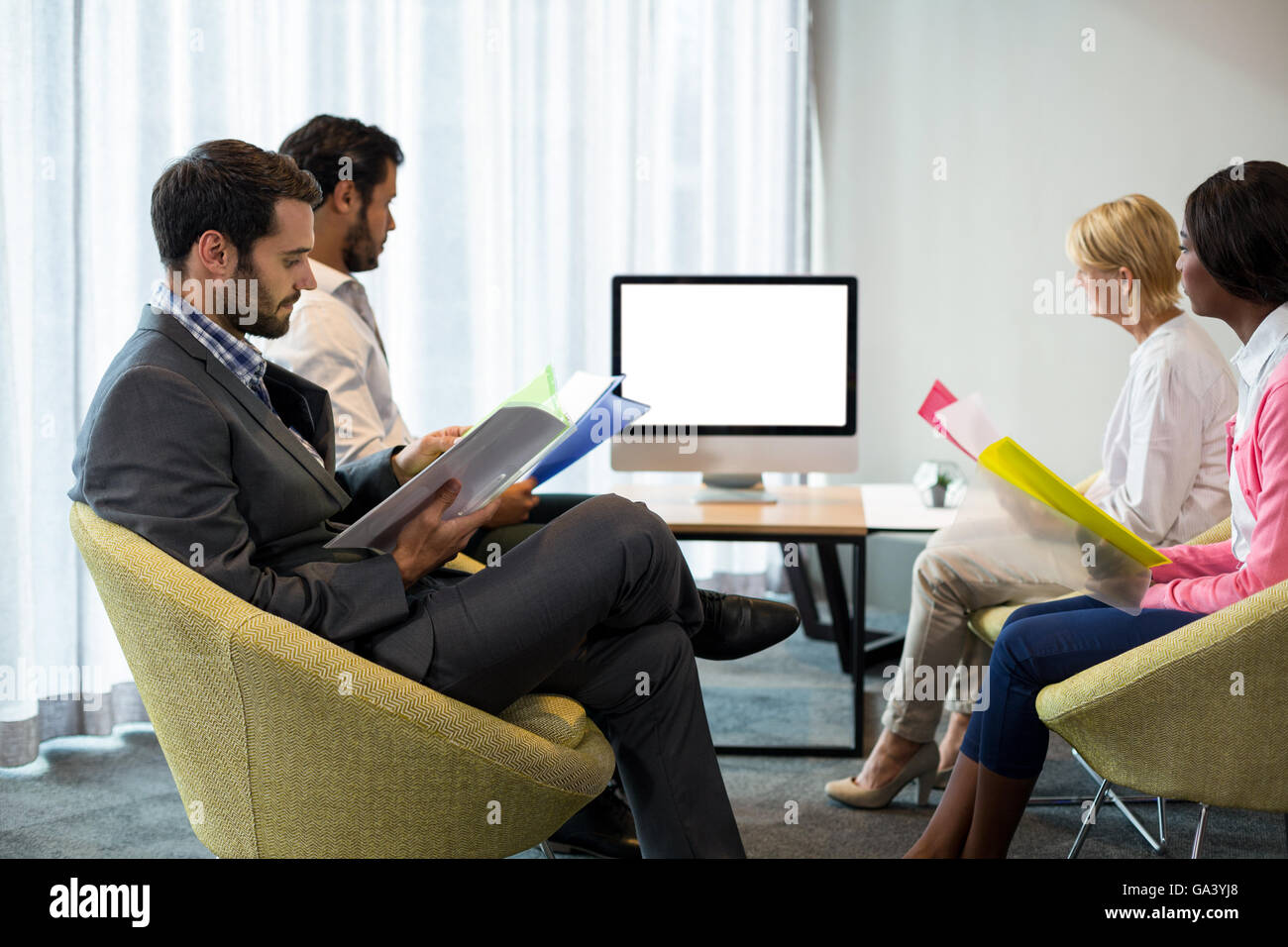 Business people looking at a screen during a video conference Stock ...