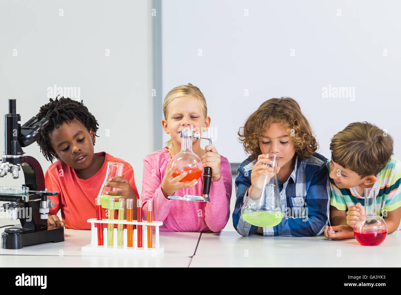 Kids doing a chemical experiment in laboratory Stock Photo - Alamy