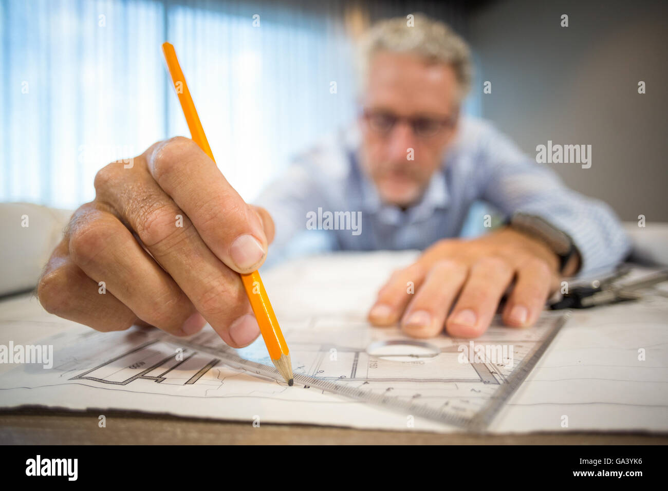 Man working on blueprint Stock Photo - Alamy
