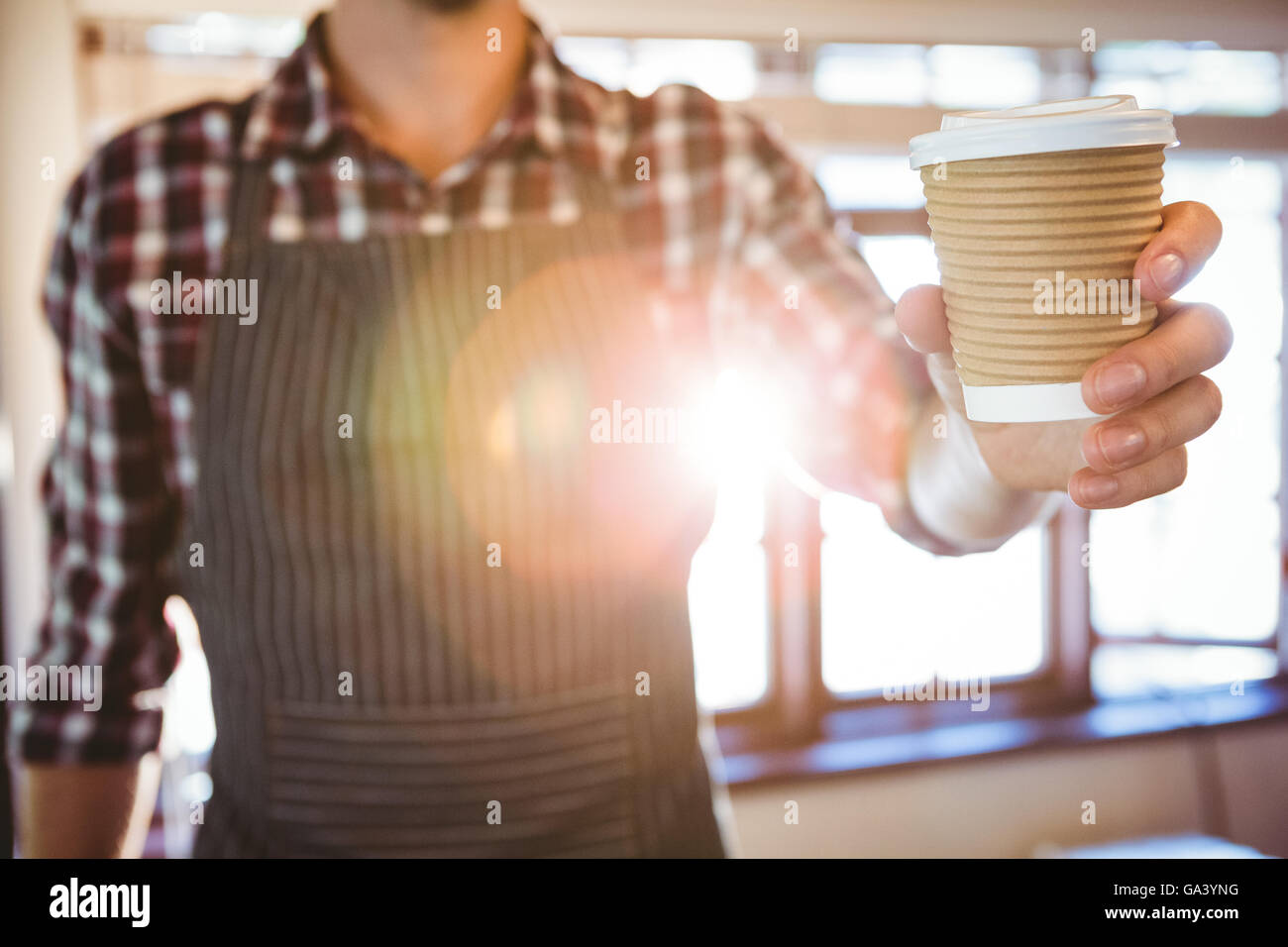 Waiter handing over a coffee Stock Photo - Alamy