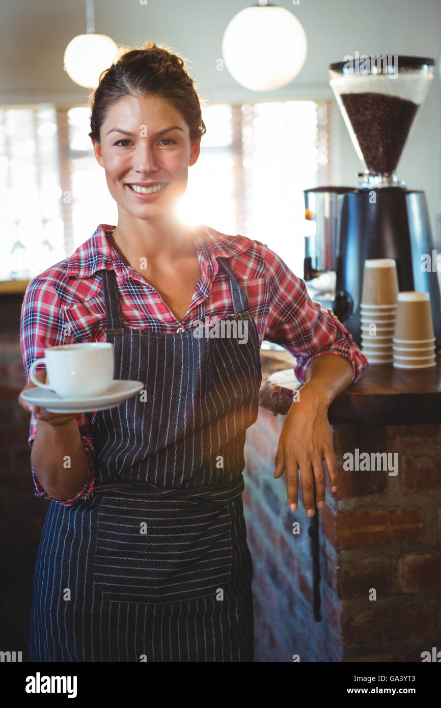 Waitress holding a cup of coffee Stock Photo - Alamy