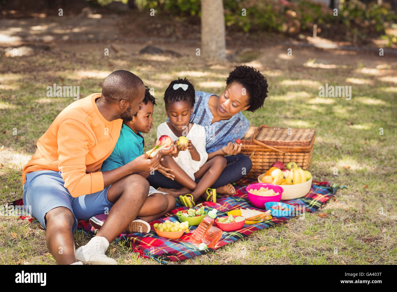 Happy family eating together Stock Photo - Alamy
