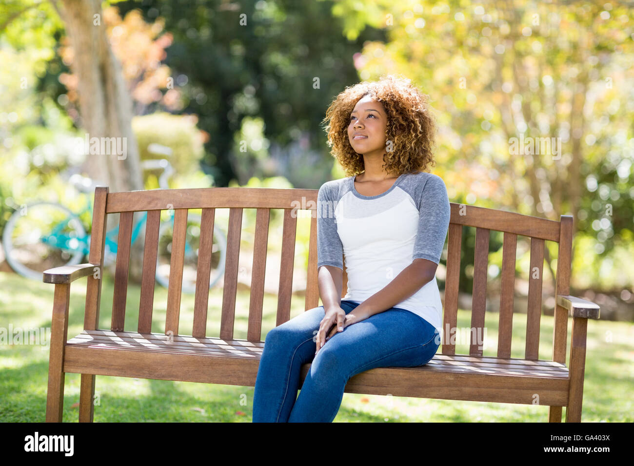 Woman sitting on the bench Stock Photo - Alamy