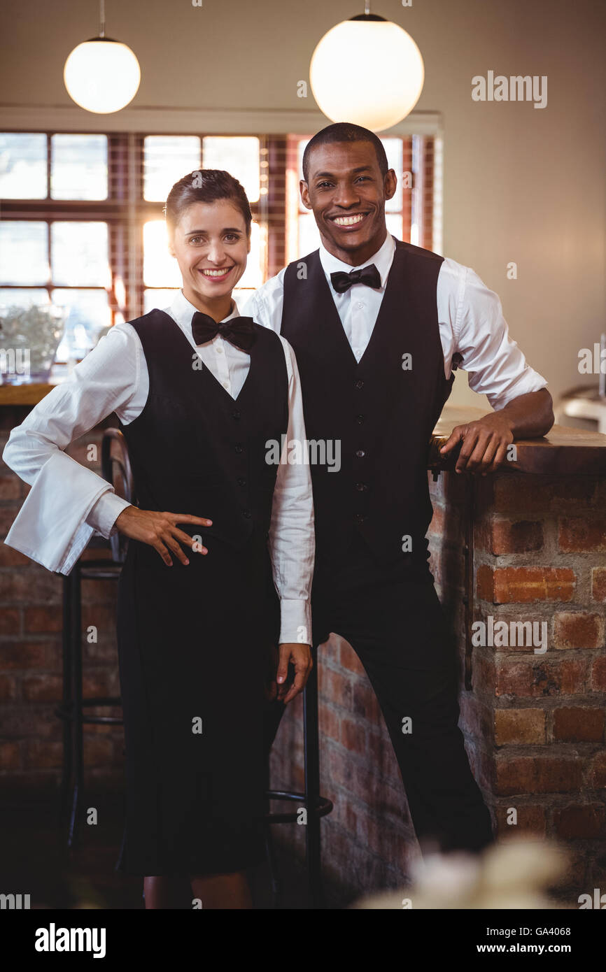 Portrait of waiter and waitress standing together Stock Photo - Alamy