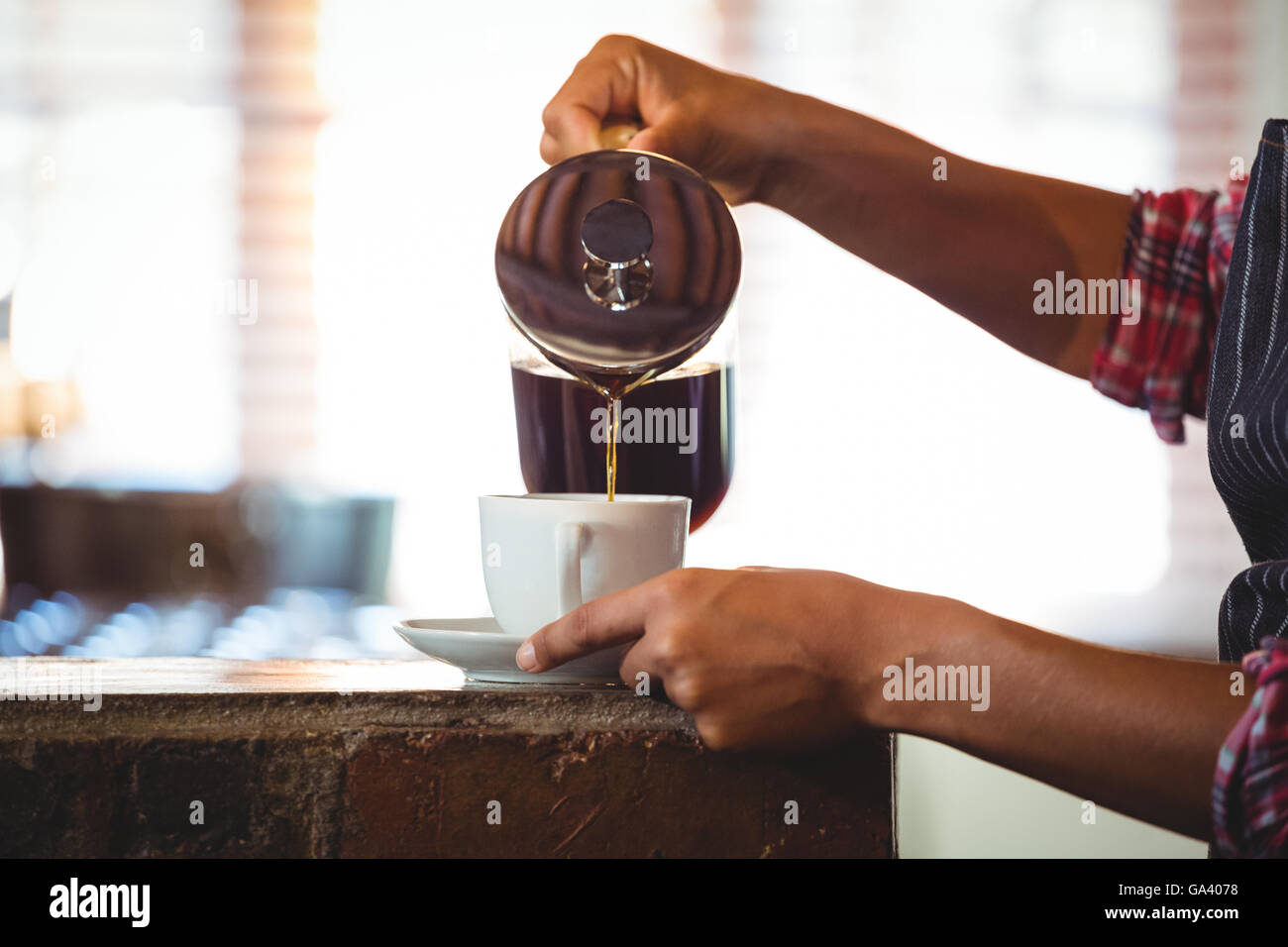 Waitress preparing a coffee Stock Photo - Alamy