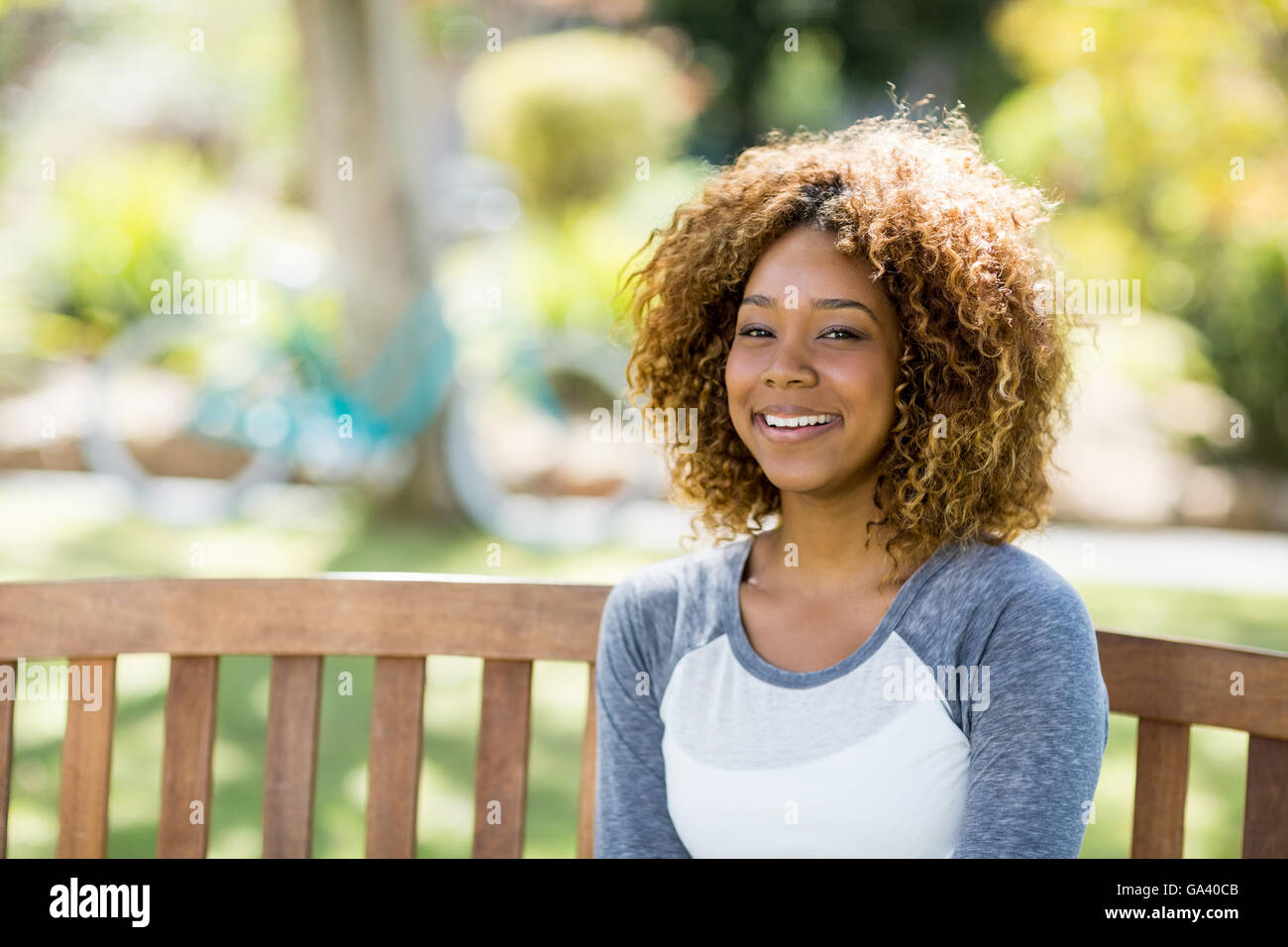 Portrait of woman sitting on the bench Stock Photo - Alamy