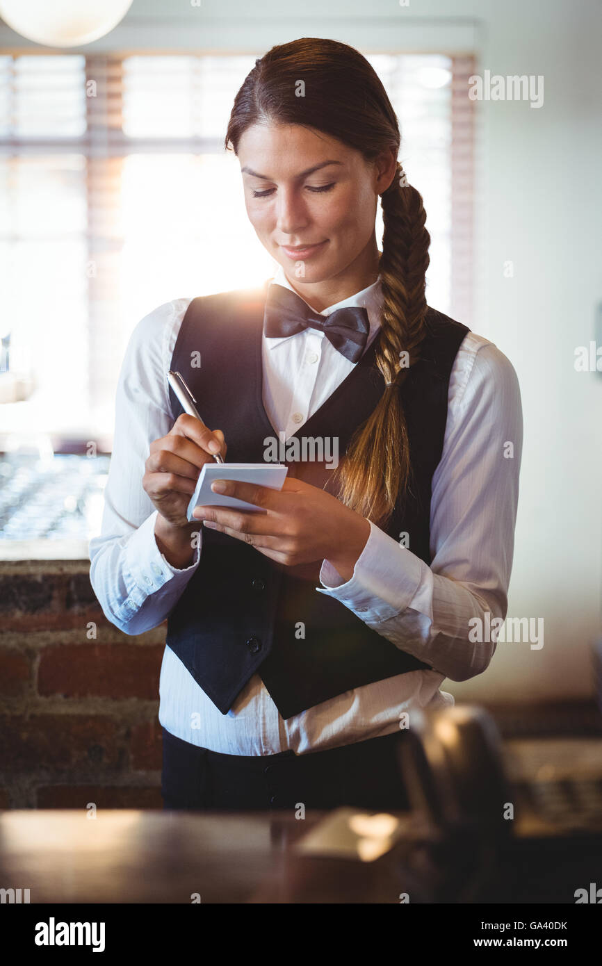 Waitress taking order on a notebook Stock Photo - Alamy