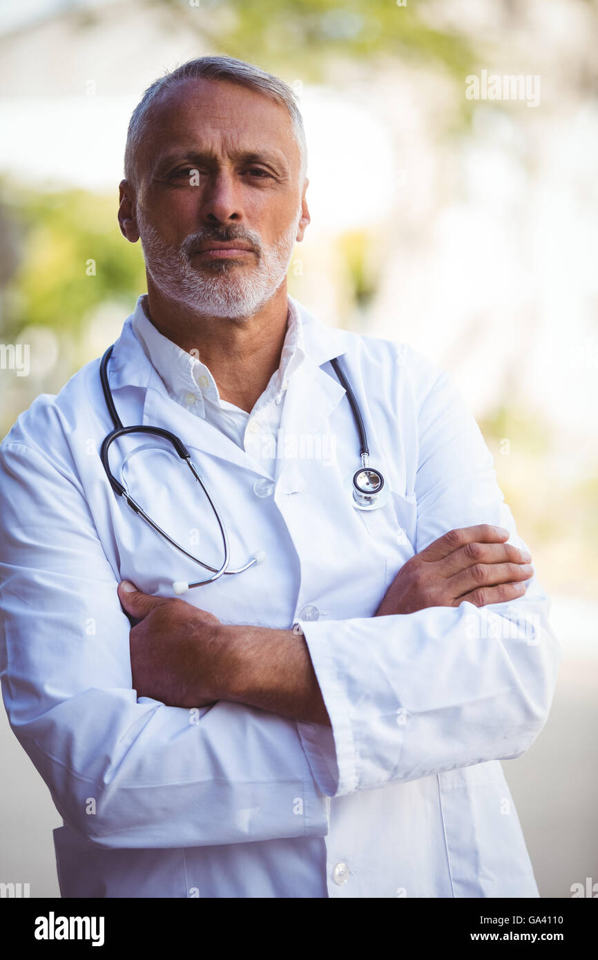 Portrait of a doctor with arm crossed Stock Photo - Alamy