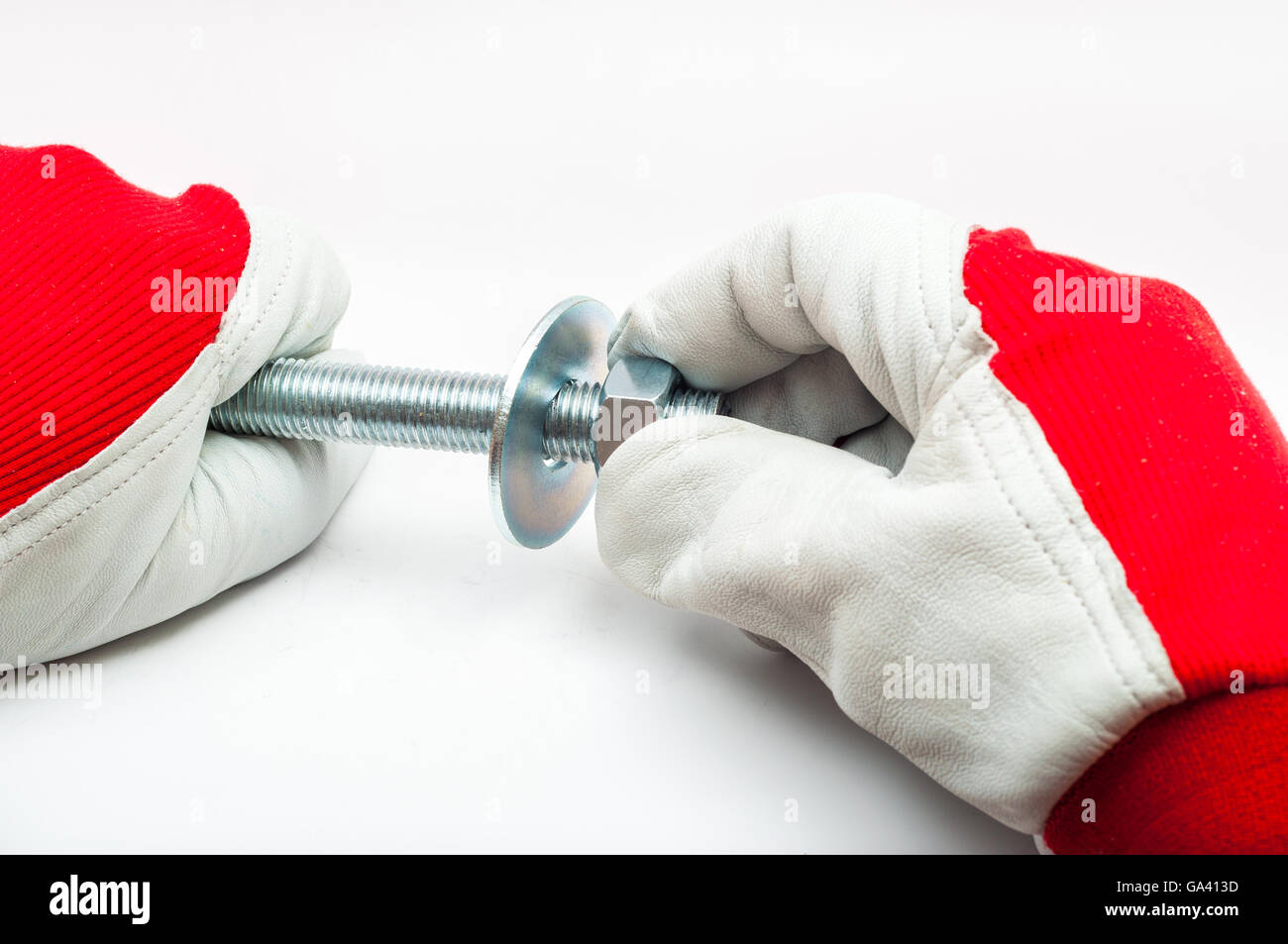 Screwing bolt by hand on white background Stock Photo - Alamy
