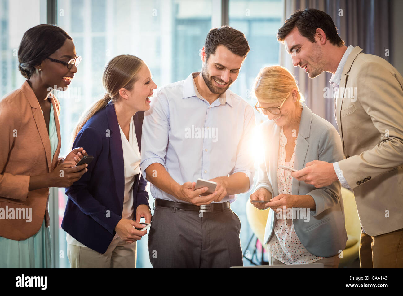 Business people interacting using mobile phone Stock Photo - Alamy